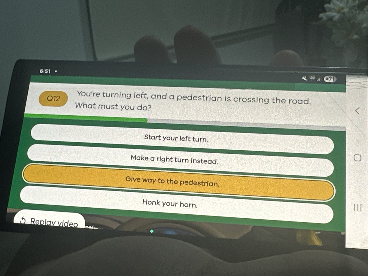 You're turning left, and a pedestrian is crossing the road. What must you..