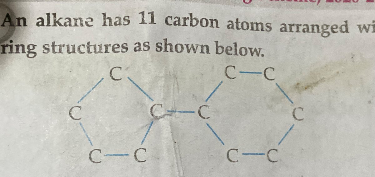 An alkane has 11 carbon atoms arranged w ring structures as shown below.