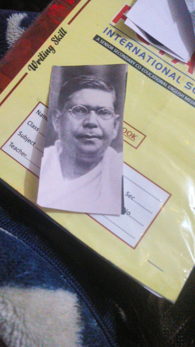 The image shows a notebook cover with the title "Writing Skill" and some