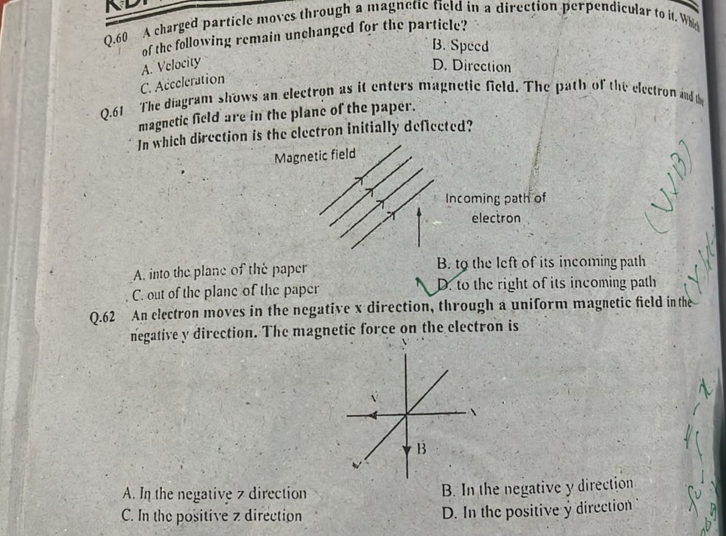 Q.60 A charged particle moves through a magnetic field in a direction per..