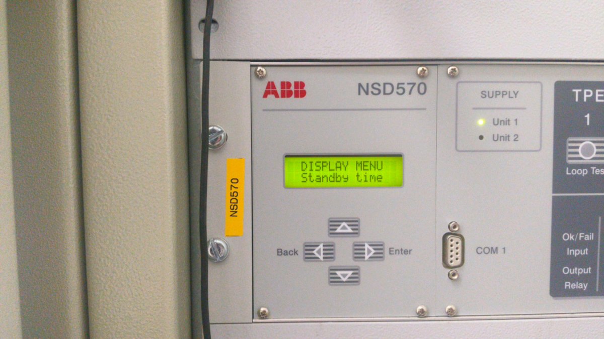 The image shows an ABB NSD570 device with a display menu showing "Standby..