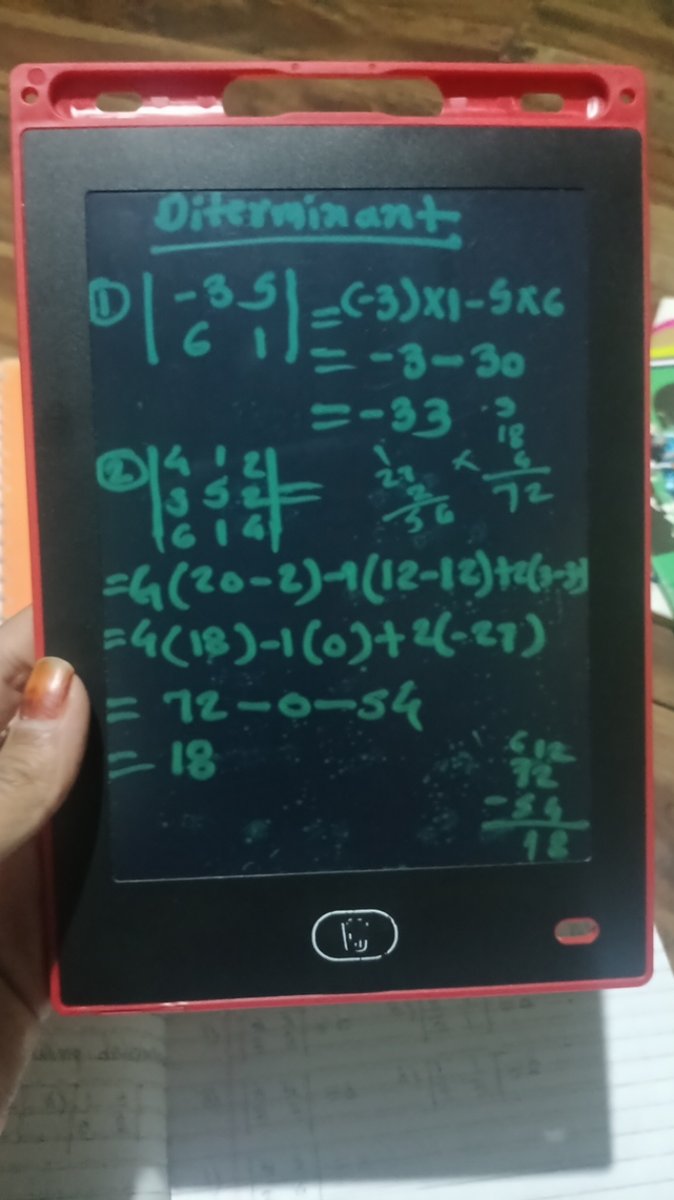 The image shows two determinant problems and their solutions. The user is..