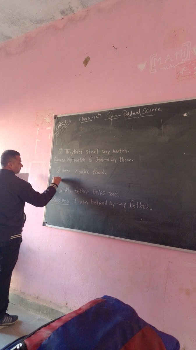 The image shows a blackboard with the following sentences written on it: