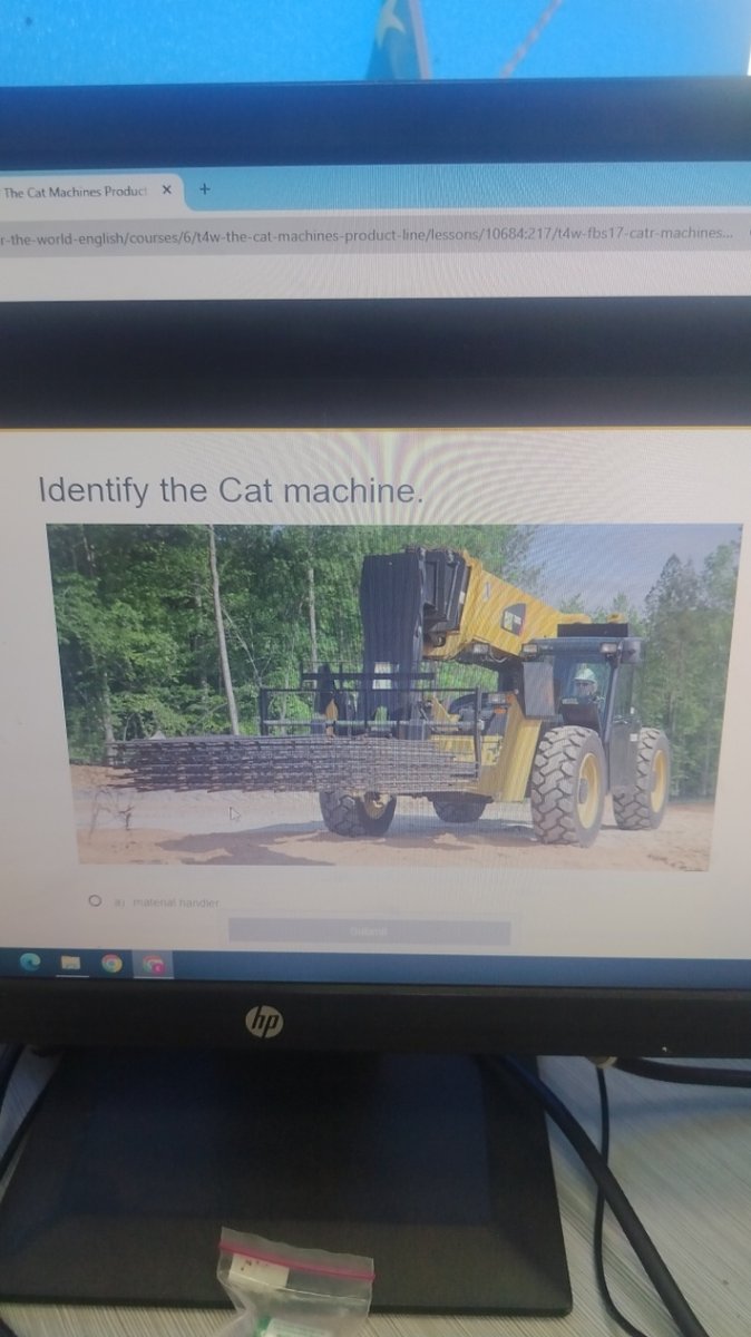 Identify the Cat machine. [Image of a yellow construction machine carryi..